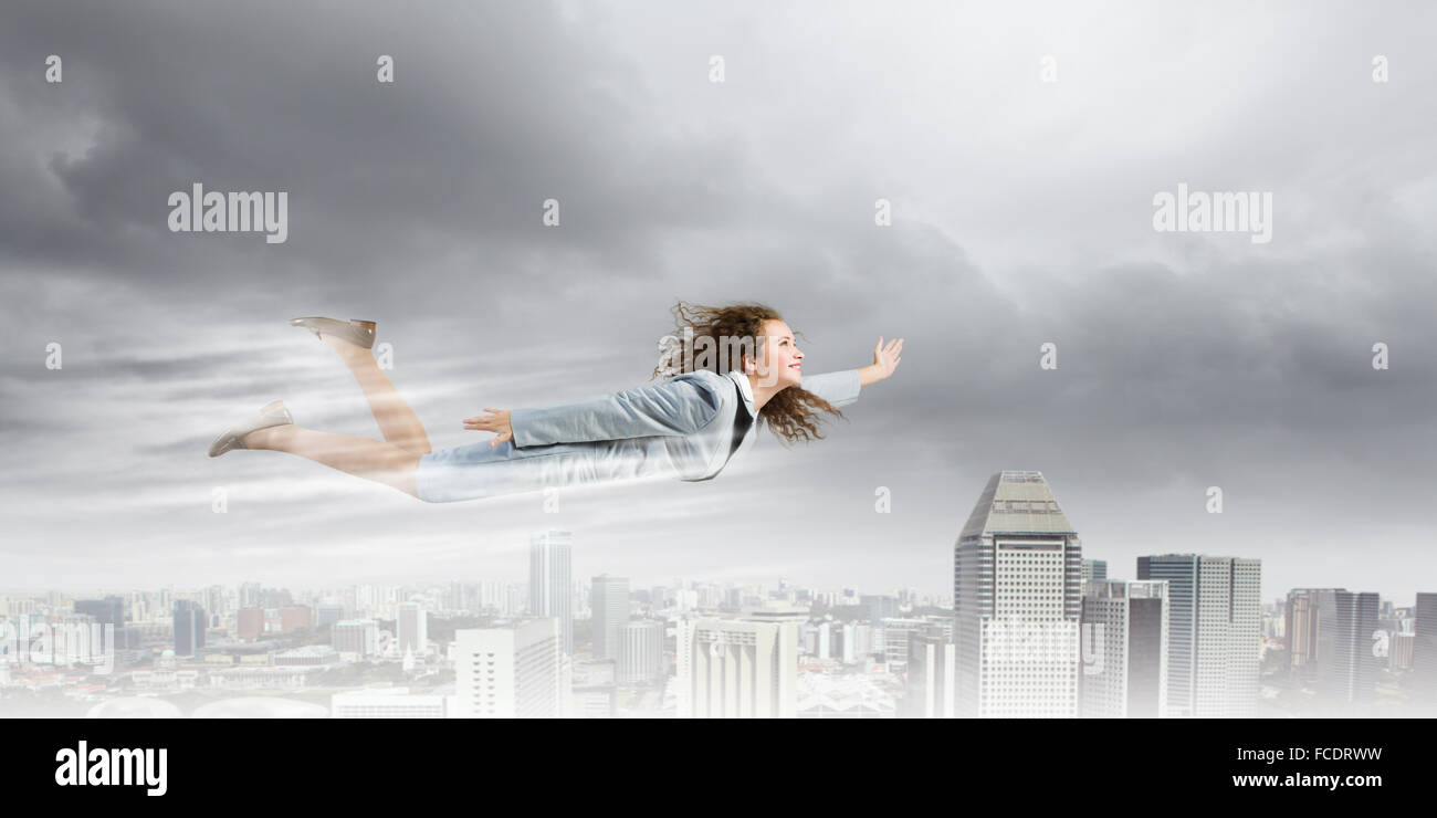 Young happy businesswoman flying high in sky Stock Photo - Alamy