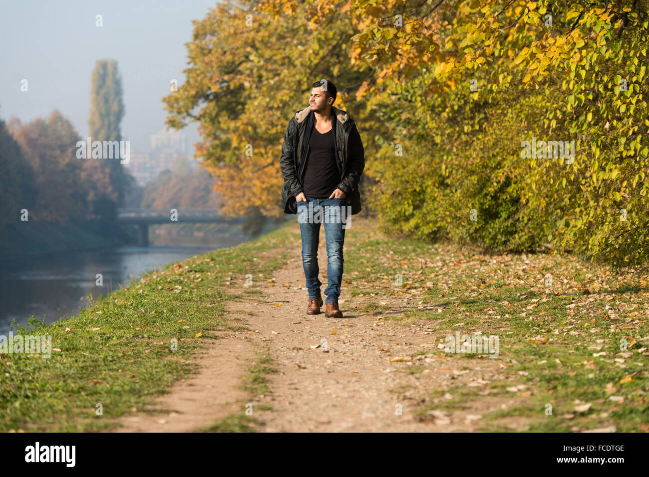 Young Man Walking In Forest Through The Woods Outside During Autumn ...