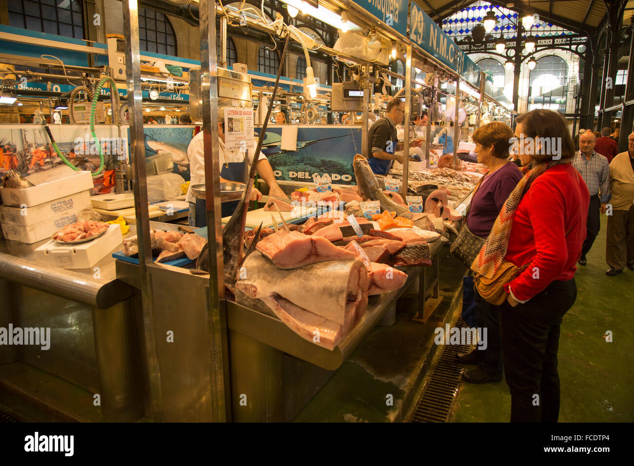 People shopping at fishmonger stalls inside historic covered market ...