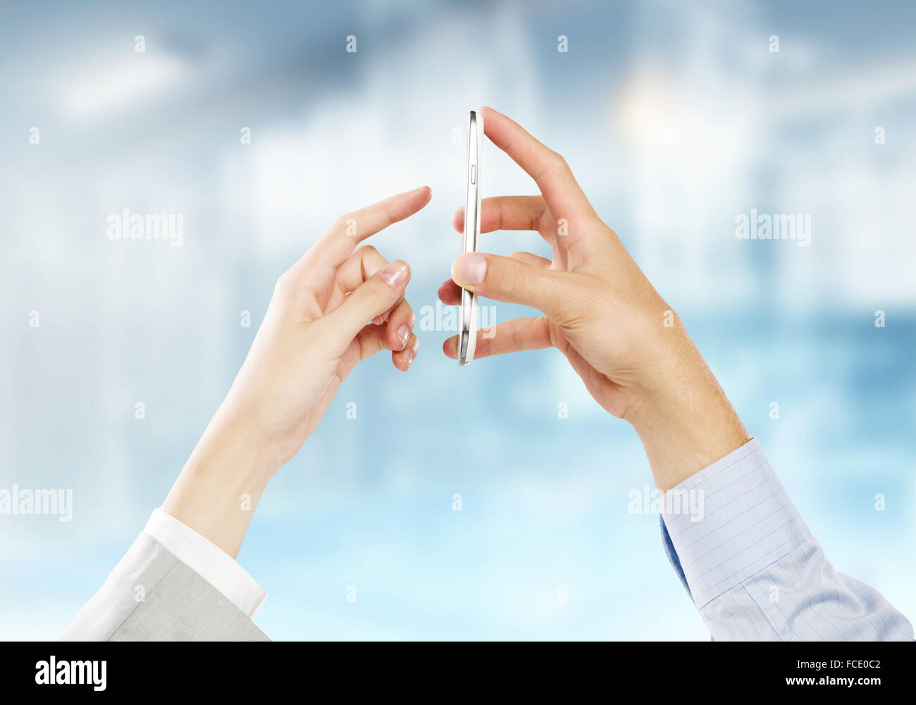 Two business people using one mobile phone at the same time Stock Photo ...