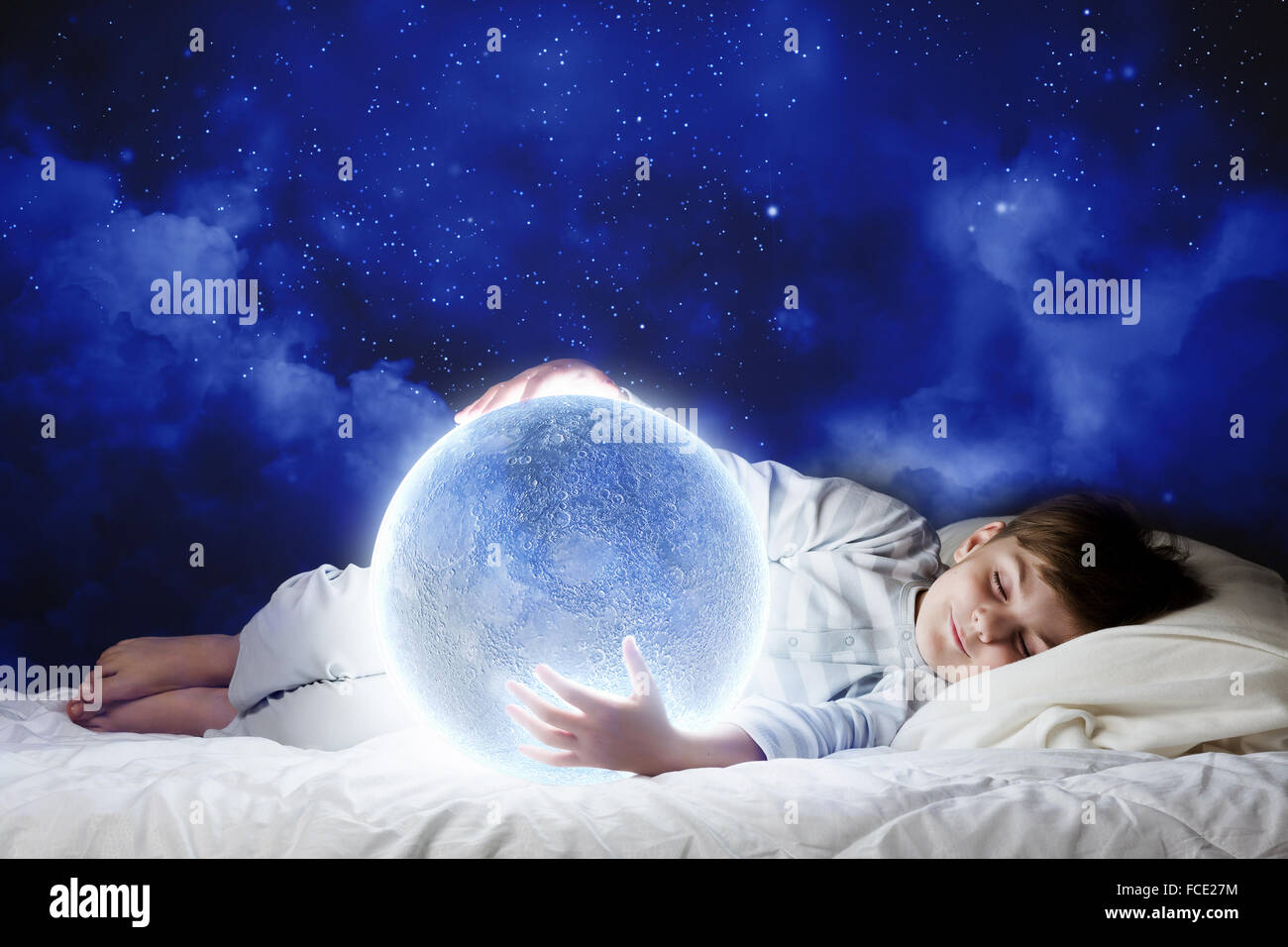 Cute boy sleeping in bed with moon Stock Photo - Alamy