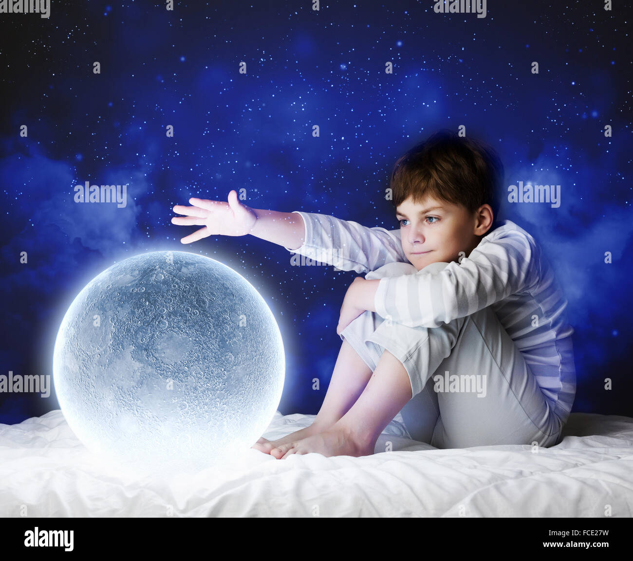 Cute boy sleeping in bed with moon Stock Photo - Alamy