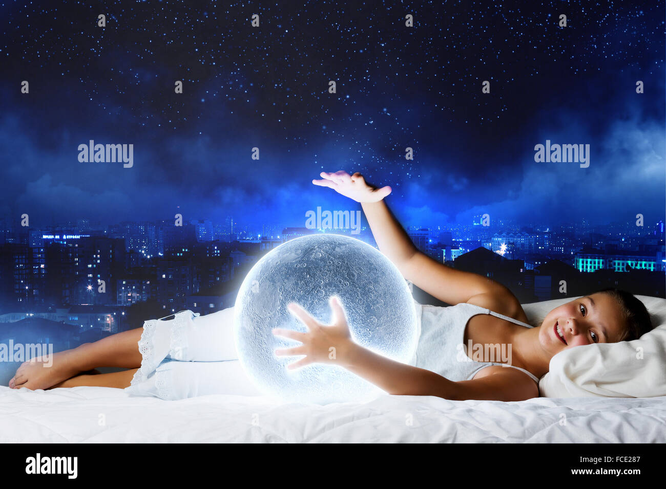 Cute girl sleeping in bed with moon Stock Photo - Alamy