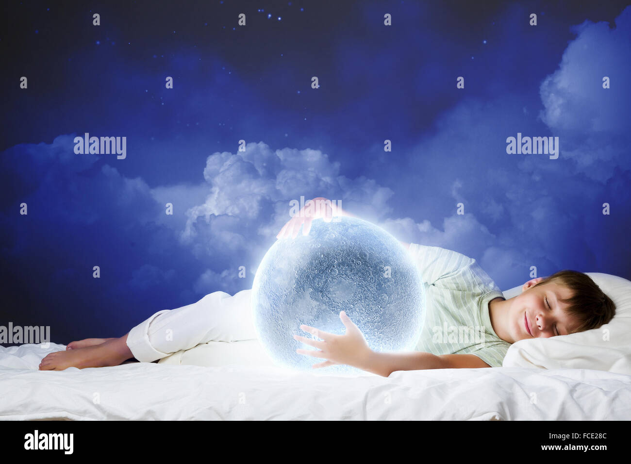 Cute boy sleeping in bed with moon Stock Photo - Alamy