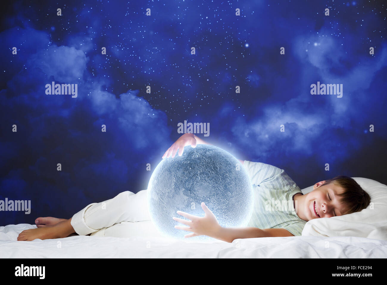 Cute boy sleeping in bed with moon Stock Photo - Alamy