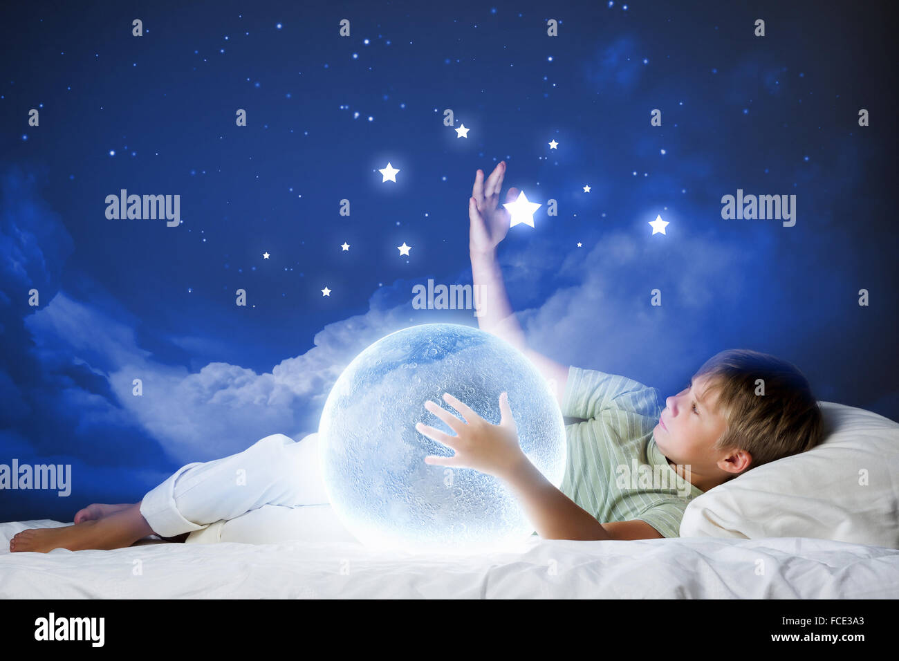 Cute boy sleeping in bed with moon Stock Photo - Alamy