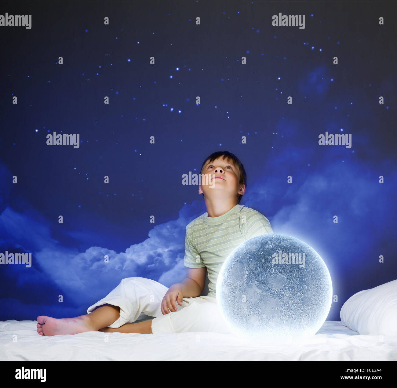 Cute boy sleeping in bed with moon Stock Photo - Alamy