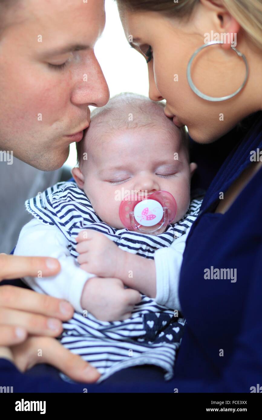 France, couple kissing his baby Stock Photo - Alamy