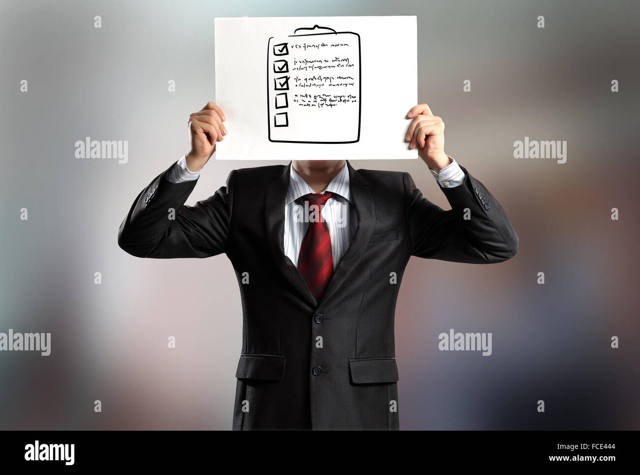 Businessman hiding his face behind paper with drawing Stock Photo - Alamy