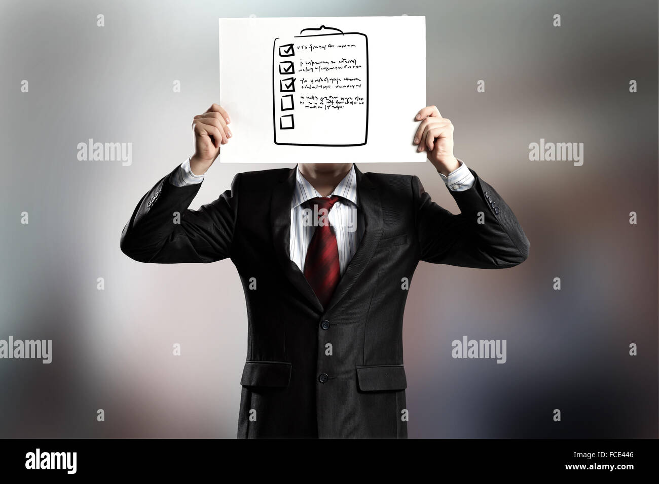 Businessman hiding his face behind paper with drawing Stock Photo - Alamy