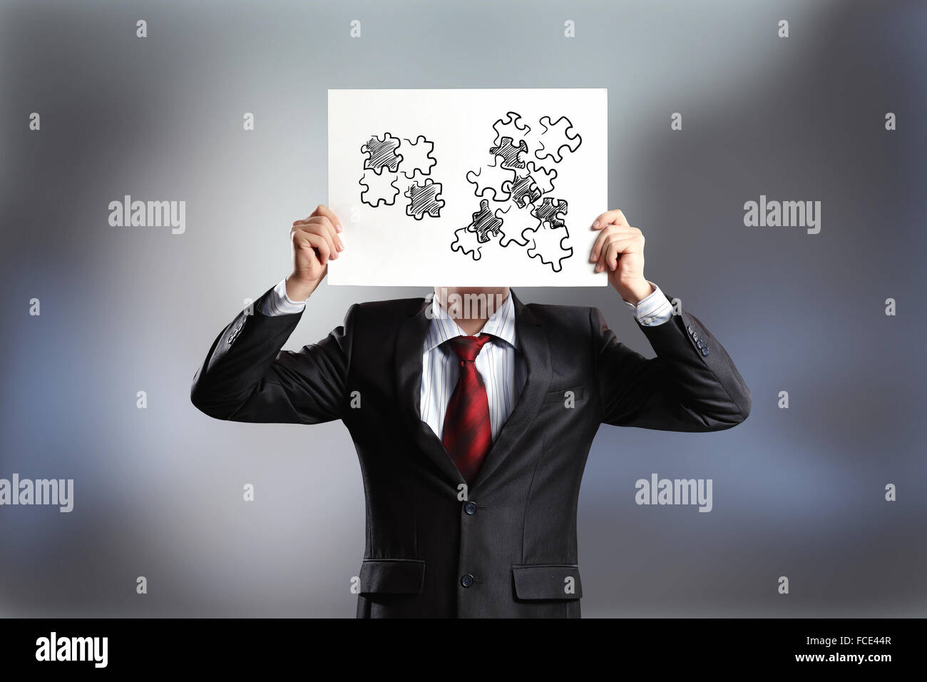 Businessman hiding his face behind paper with drawing Stock Photo - Alamy