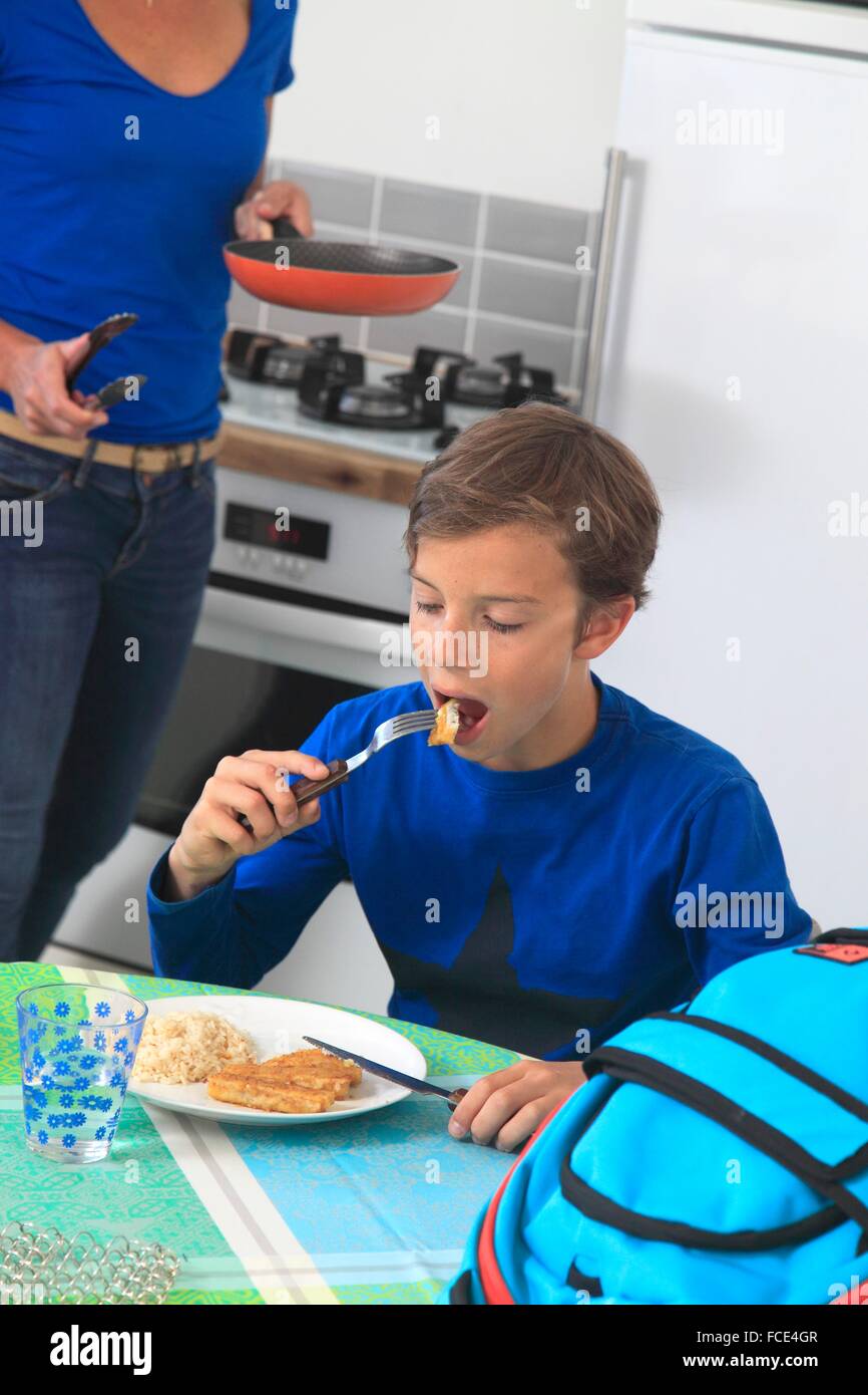 Child eating breaded fish hi-res stock photography and images - Alamy