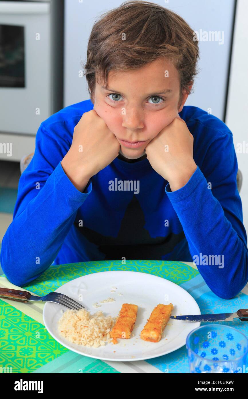 France, child eating breaded fish Stock Photo - Alamy