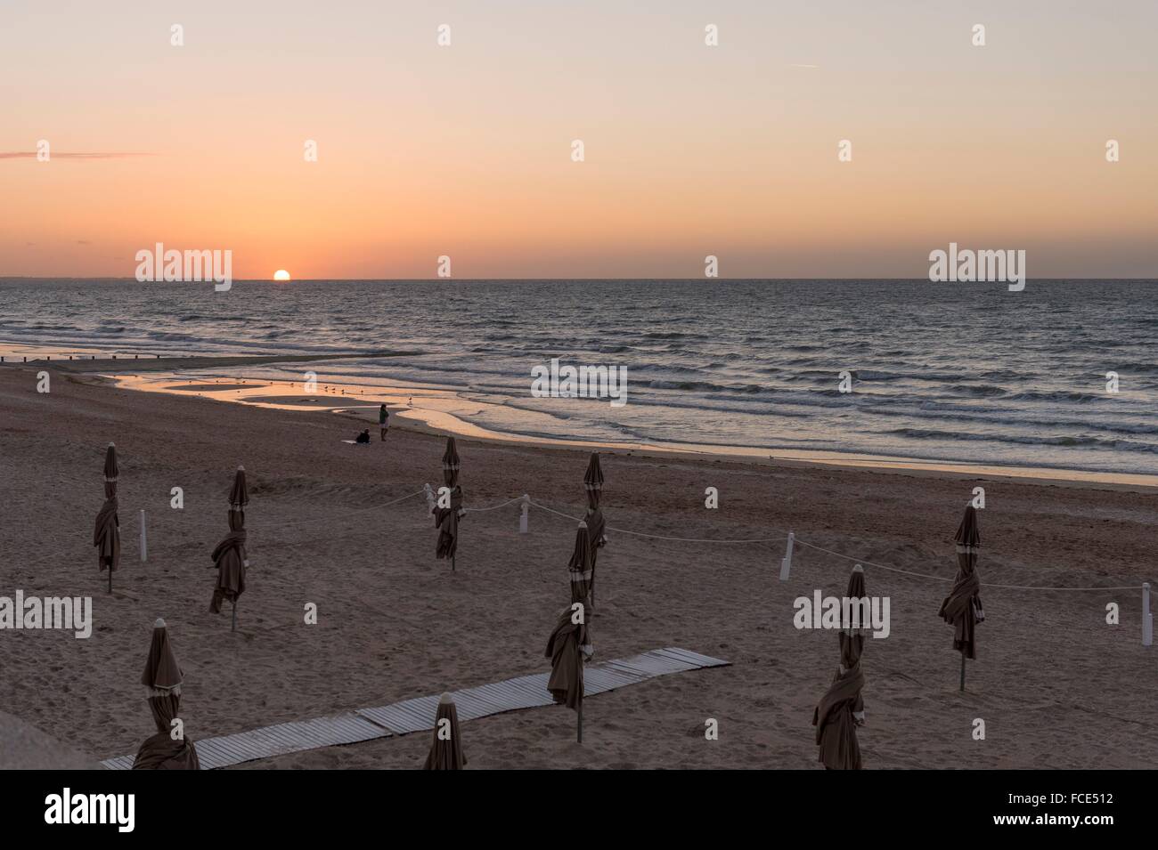 France, Normandy, beach umbrellas on the beach at sunset Stock Photo ...