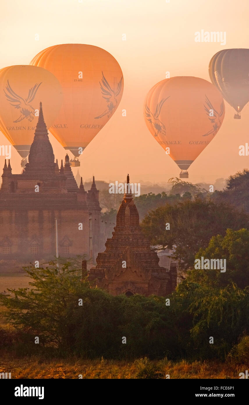 Hot air balloons at sunrise over ancient temples in Bagan, Myanmar ...