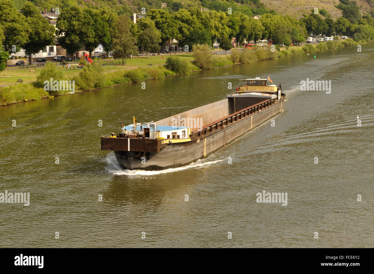 A cargo barge travels up the River Moselle at Cochem, Germany, in ...