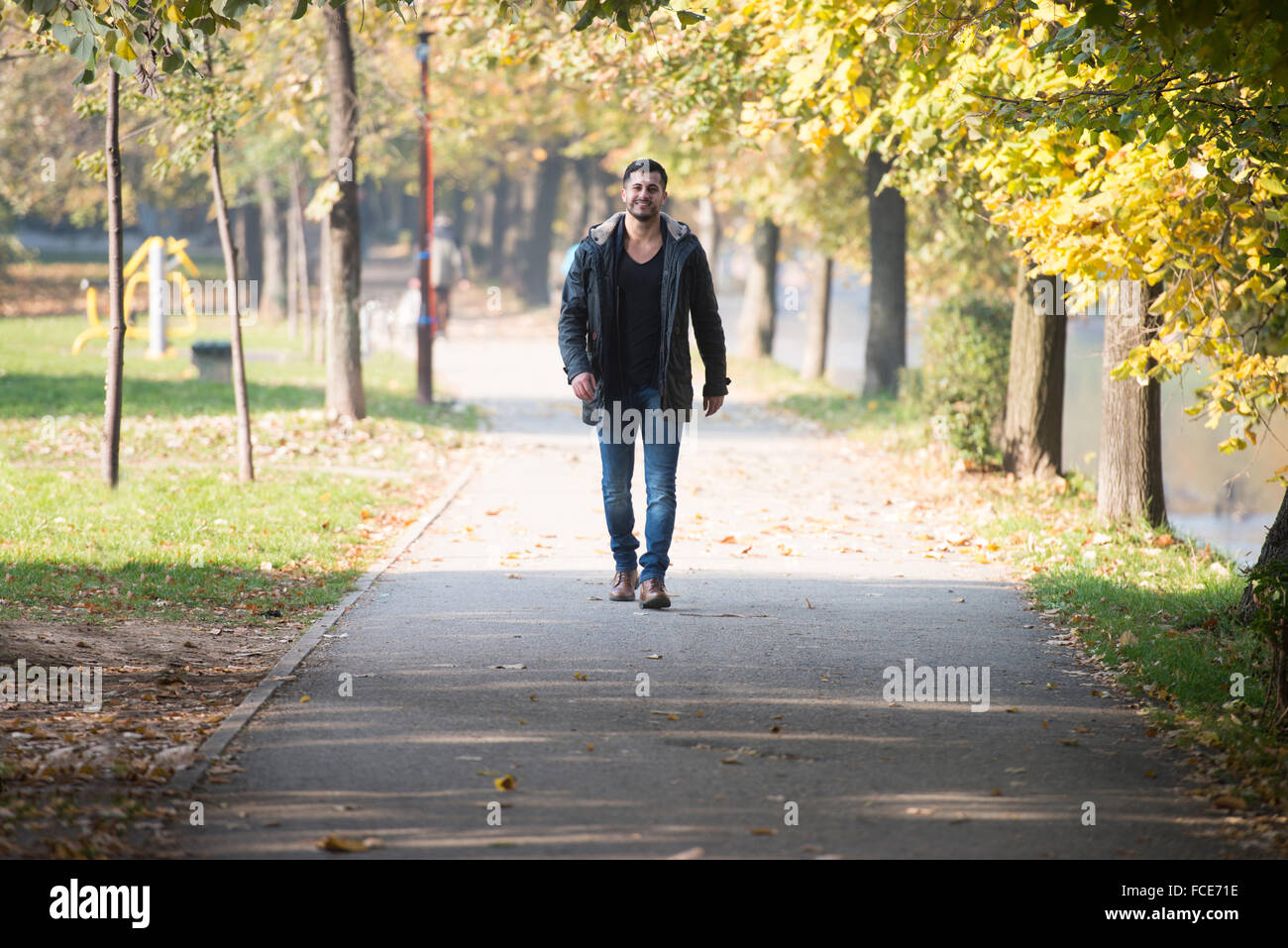 Young Man Walking In Forest Through The Woods Outside During Autumn ...