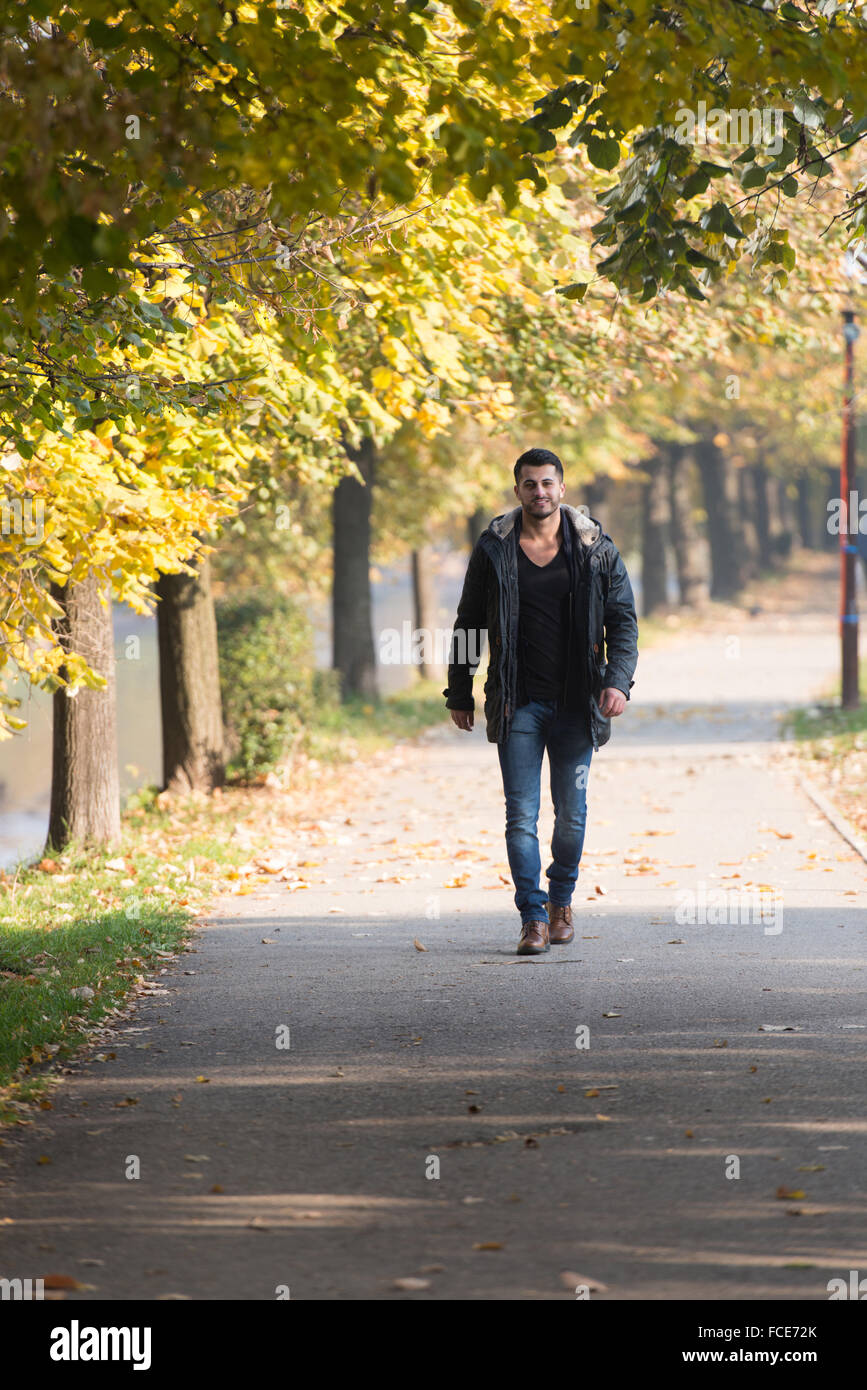 Young Man Walking In Forest Through The Woods Outside During Autumn ...