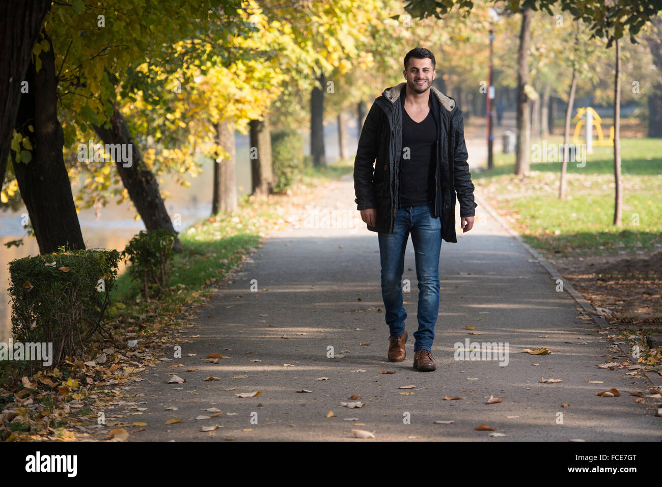 Young Man Walking In Forest Through The Woods Outside During Autumn ...