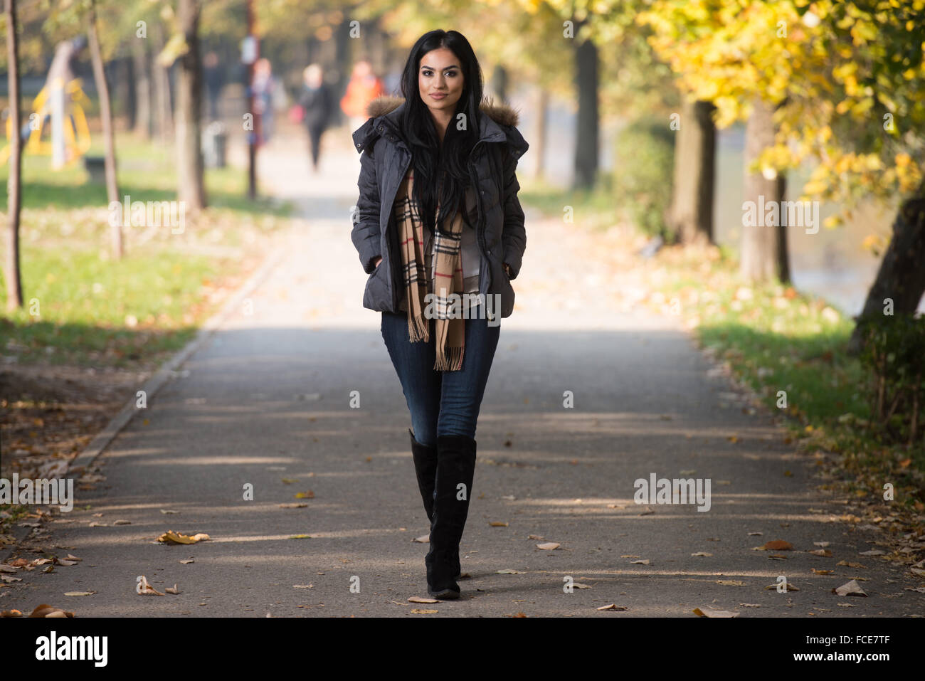 Young Woman Walking In Forest Through The Woods Outside During Autumn ...