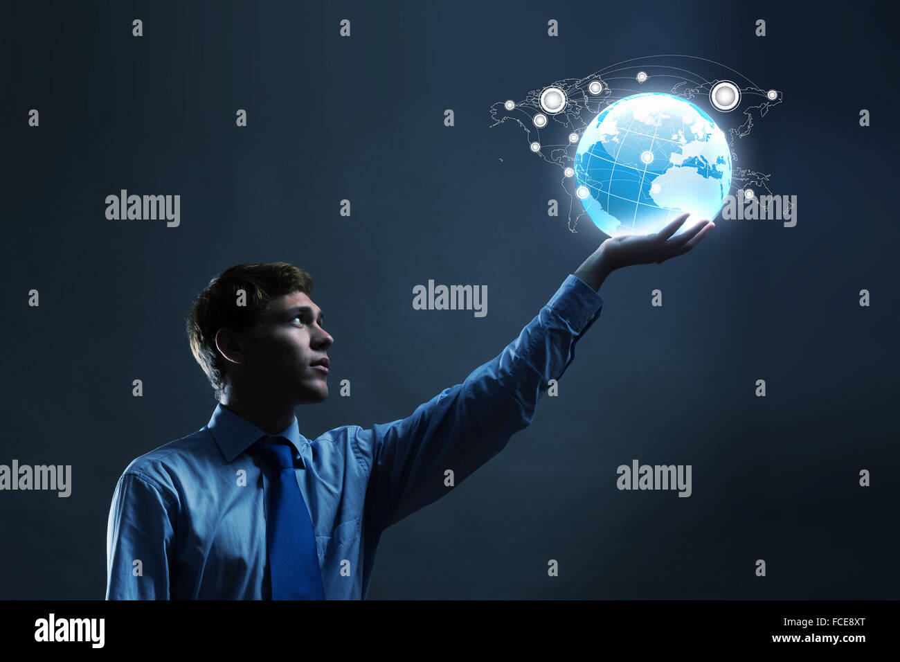 Businessman holding digital Earth planet in hand Stock Photo - Alamy