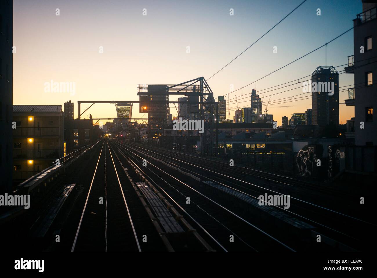 Urban view of the City of London at sunset from the DLR Docklands rails ...