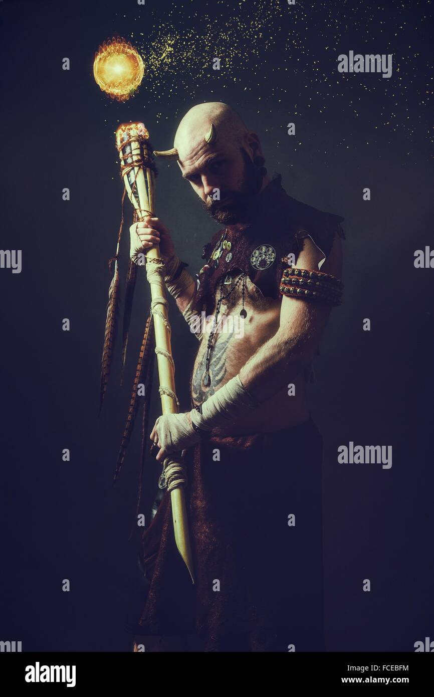 Creature holding a magic stick Stock Photo - Alamy