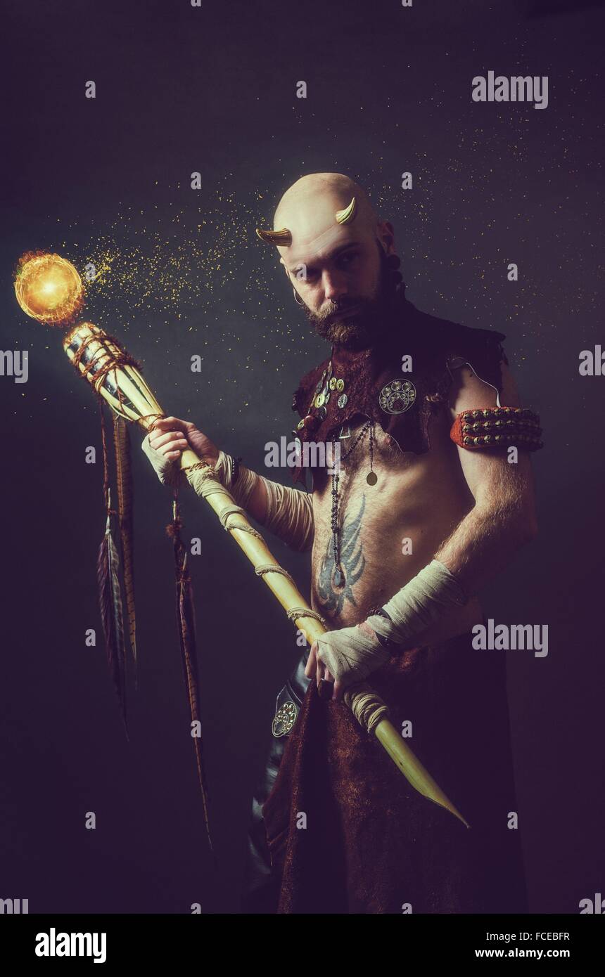 Creature holding a magic stick Stock Photo - Alamy
