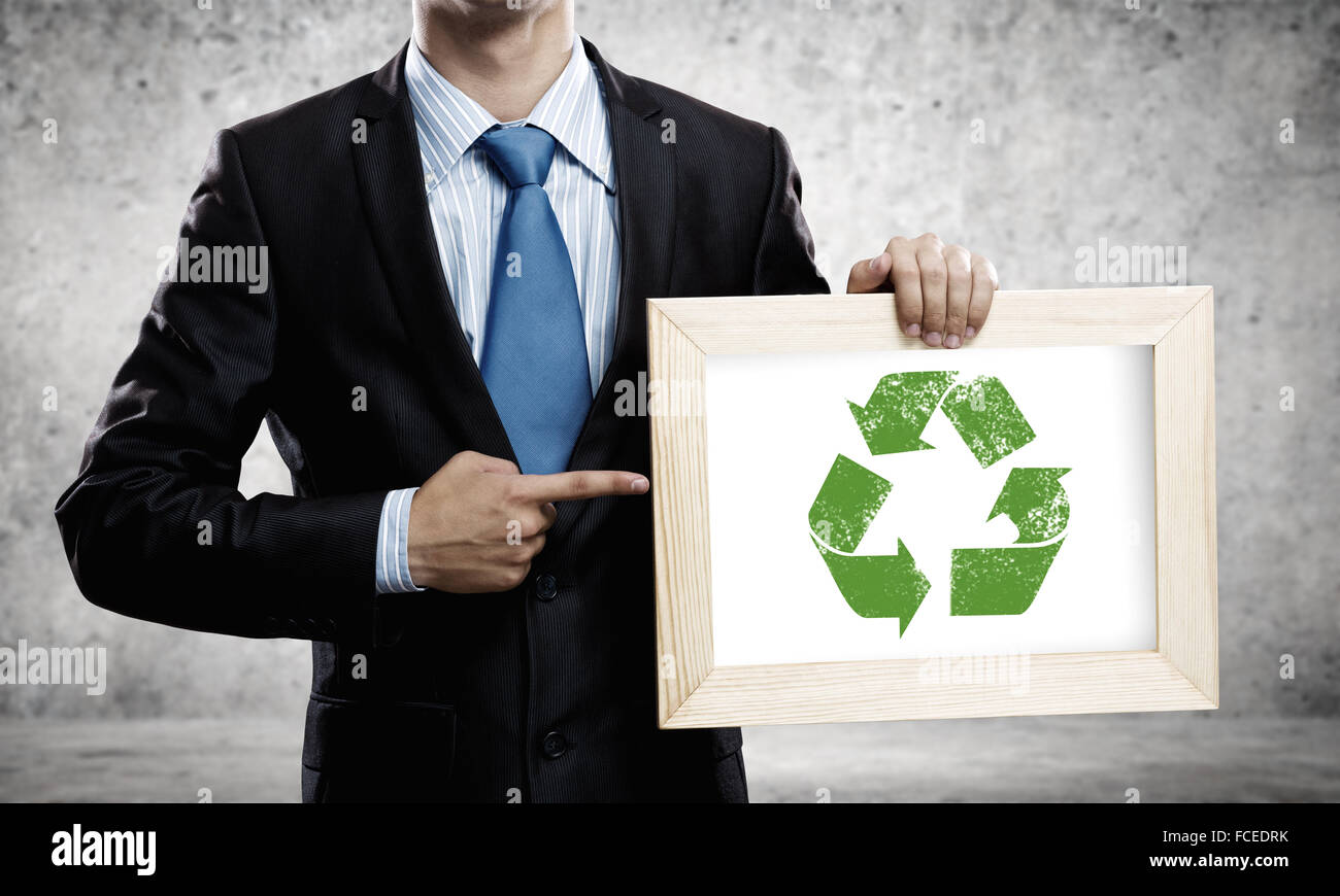 Close up of businessman holding frame with recycle sign Stock Photo - Alamy