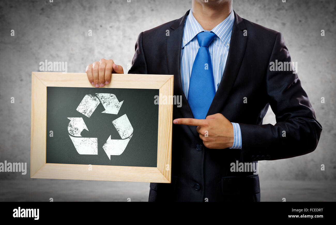 Close up of businessman holding frame with recycle sign Stock Photo - Alamy