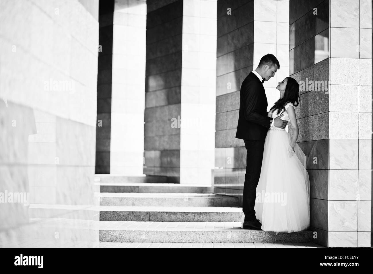 Wedding couple under high-tech columns with shadows Stock Photo - Alamy