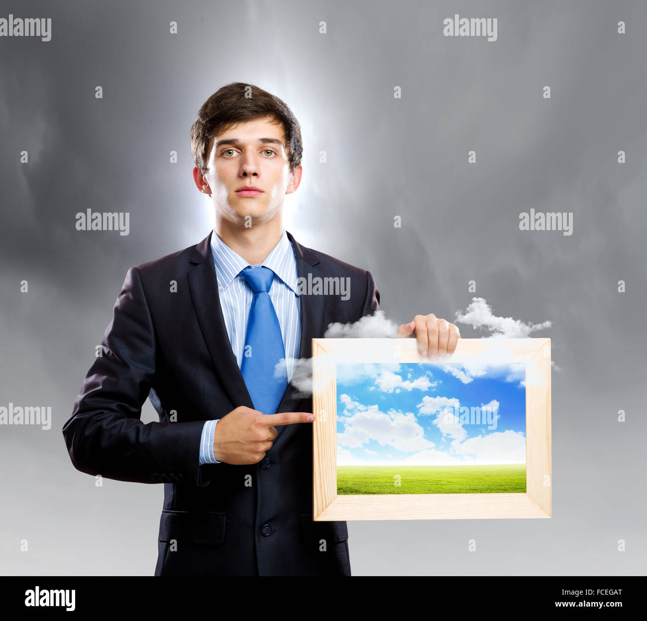 Handsome young man holding frame with pictures Stock Photo - Alamy