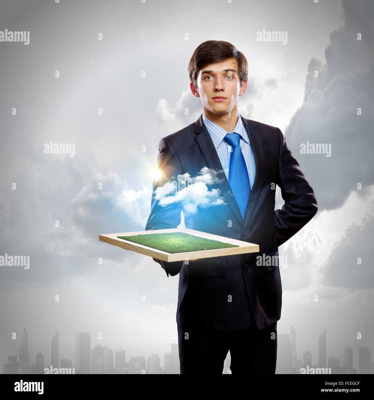 Handsome young man holding frame with pictures Stock Photo - Alamy