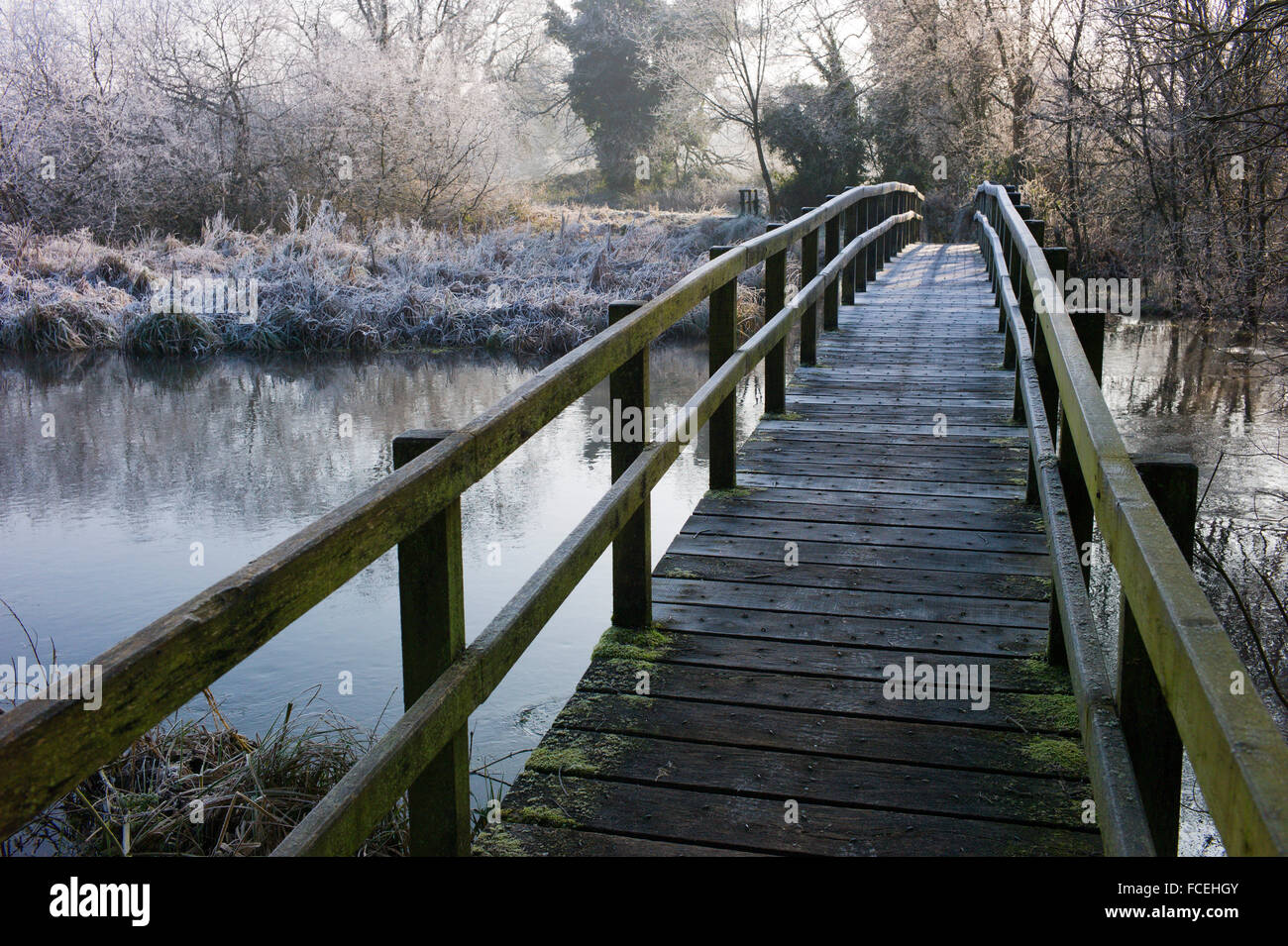 A foot bridge across the River Test with a hard morning frost on the ...