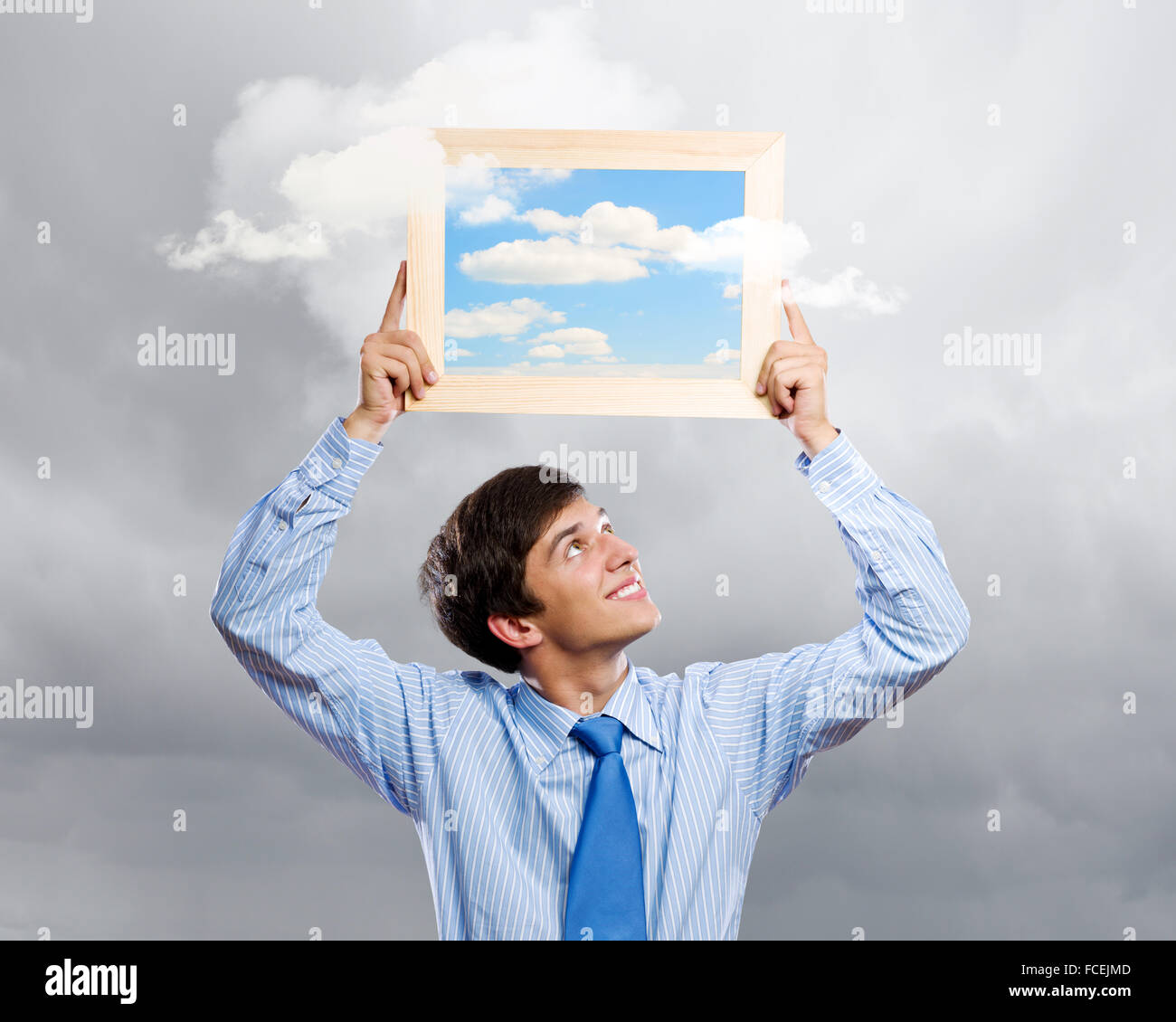 Handsome young man holding frame with pictures Stock Photo - Alamy
