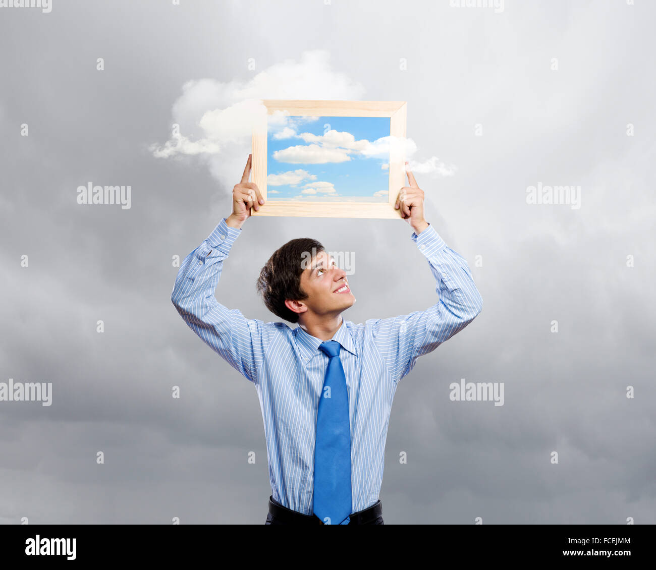 Handsome young man holding frame with pictures Stock Photo - Alamy