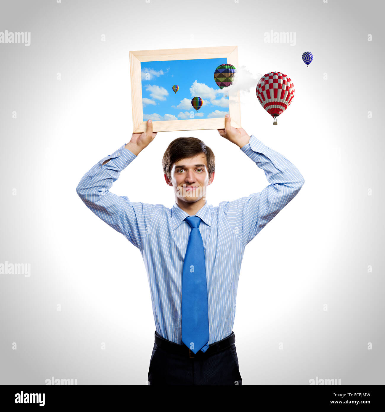 Handsome young man holding frame with pictures hi-res stock photography ...