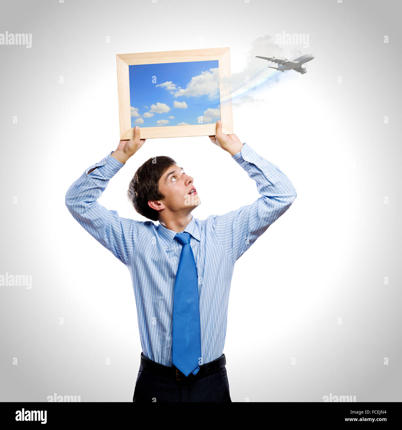 Handsome young man holding frame with pictures Stock Photo - Alamy