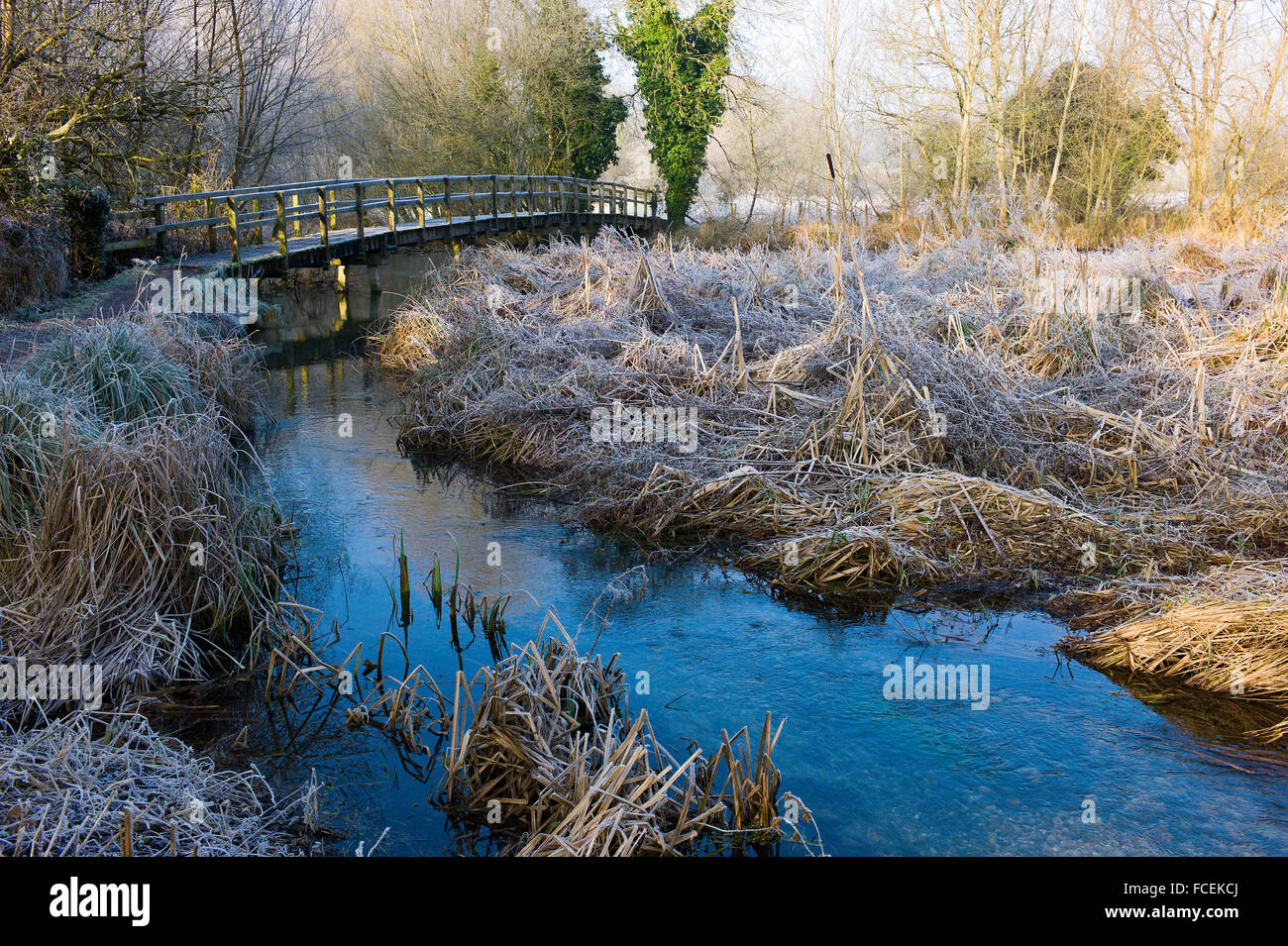 A footbridge across the River Test with a hard morning frost on the ...