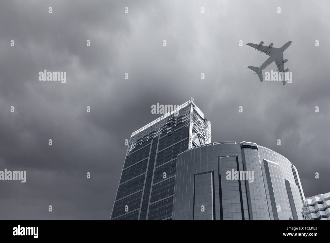 Bottom view of airplane flying above skyscrapers Stock Photo - Alamy