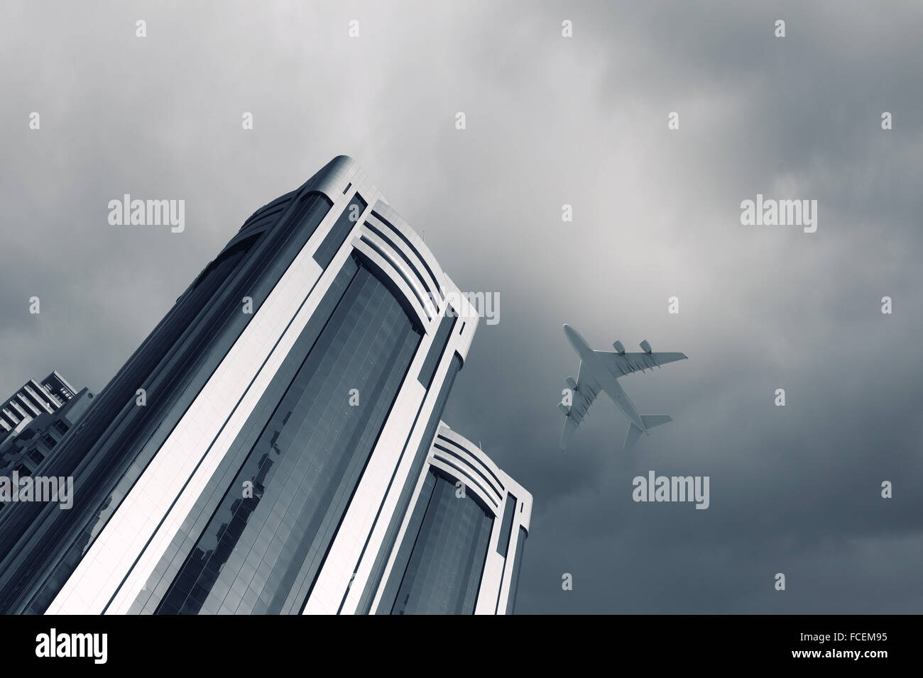 Bottom view of airplane flying above skyscrapers Stock Photo - Alamy