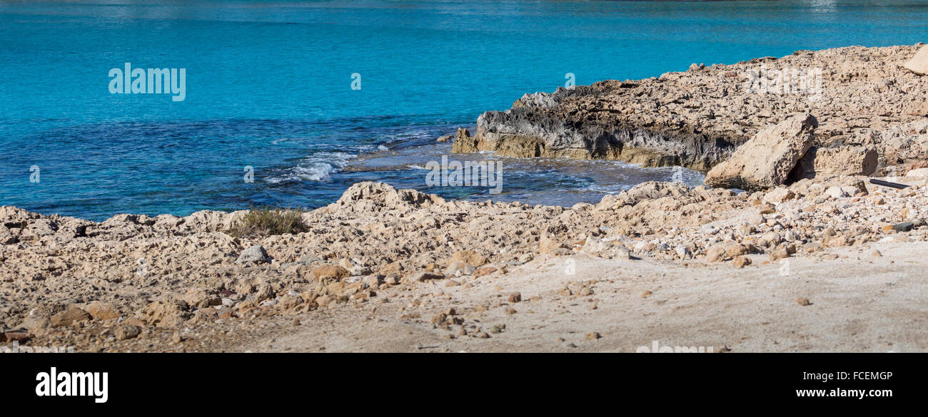 wild beach with rocks in water Stock Photo - Alamy