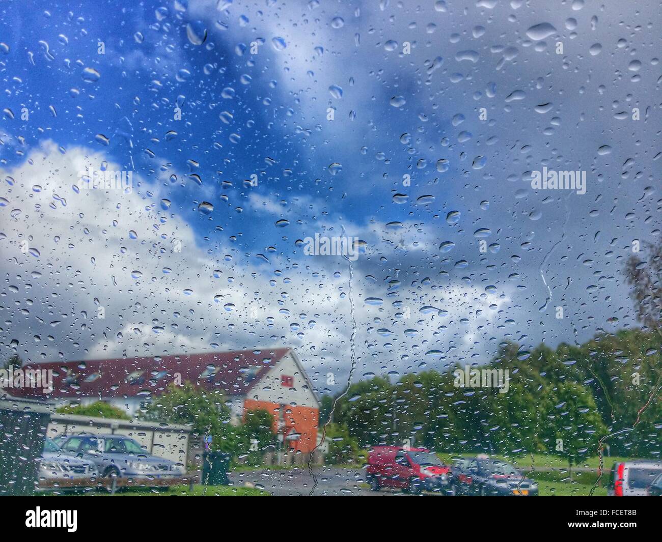 View Of Town Through Wet Window Stock Photo - Alamy