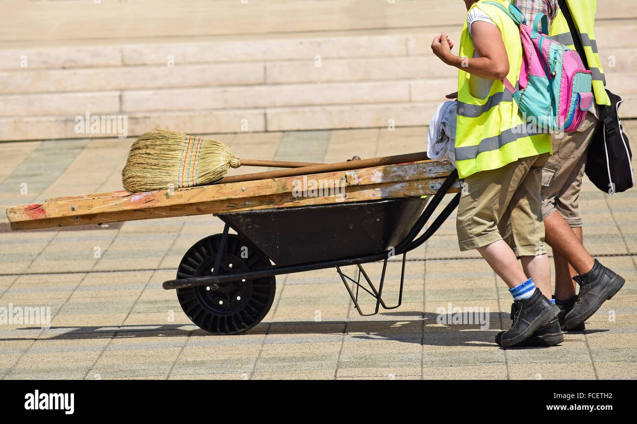 Workers with wheelbarrow Stock Photo - Alamy