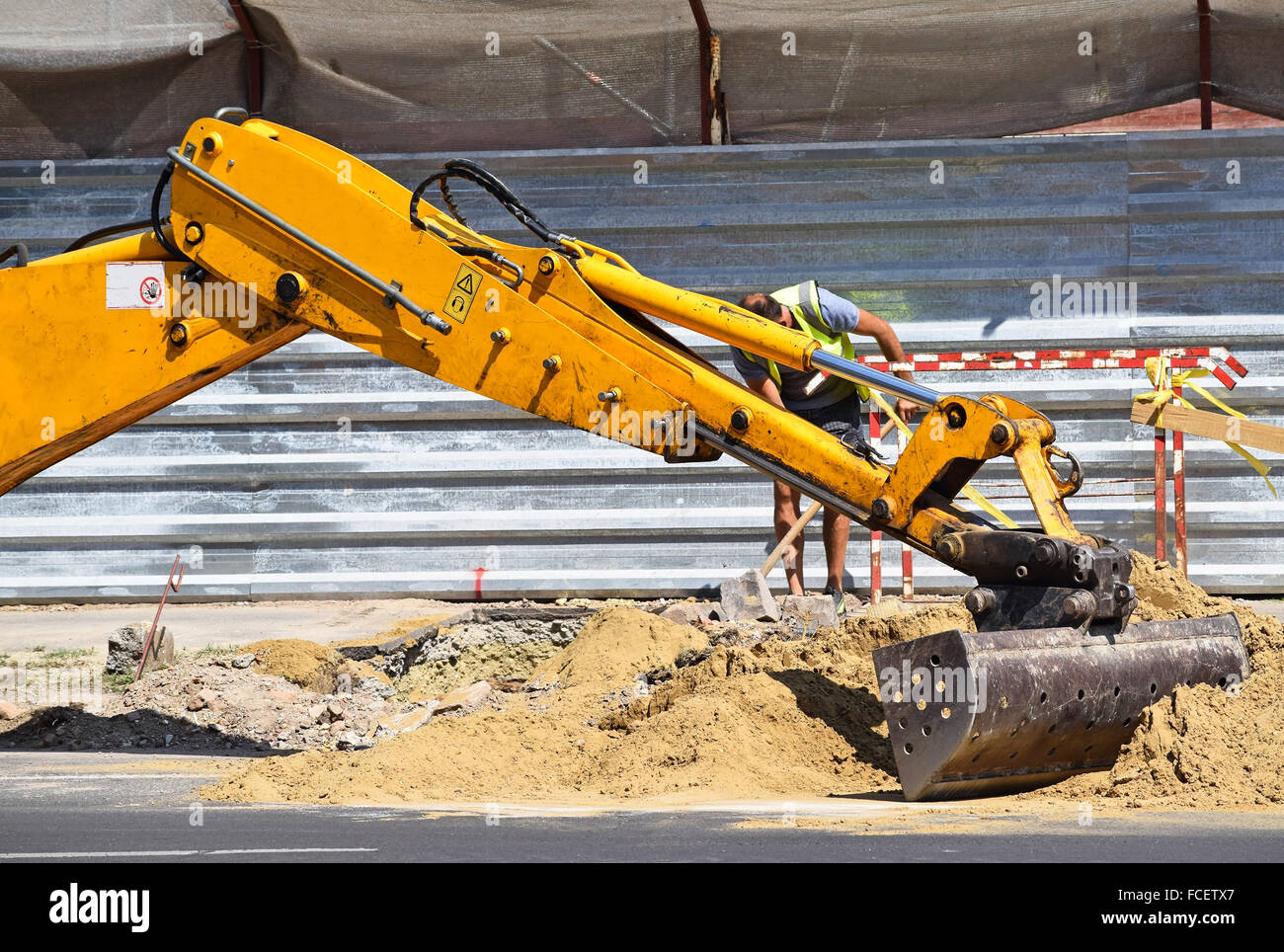 Excavator at the road construction Stock Photo - Alamy