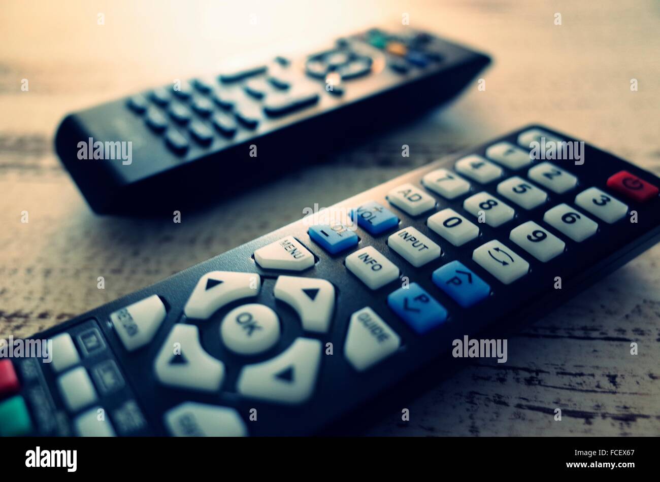 TV remotes on a table Stock Photo - Alamy