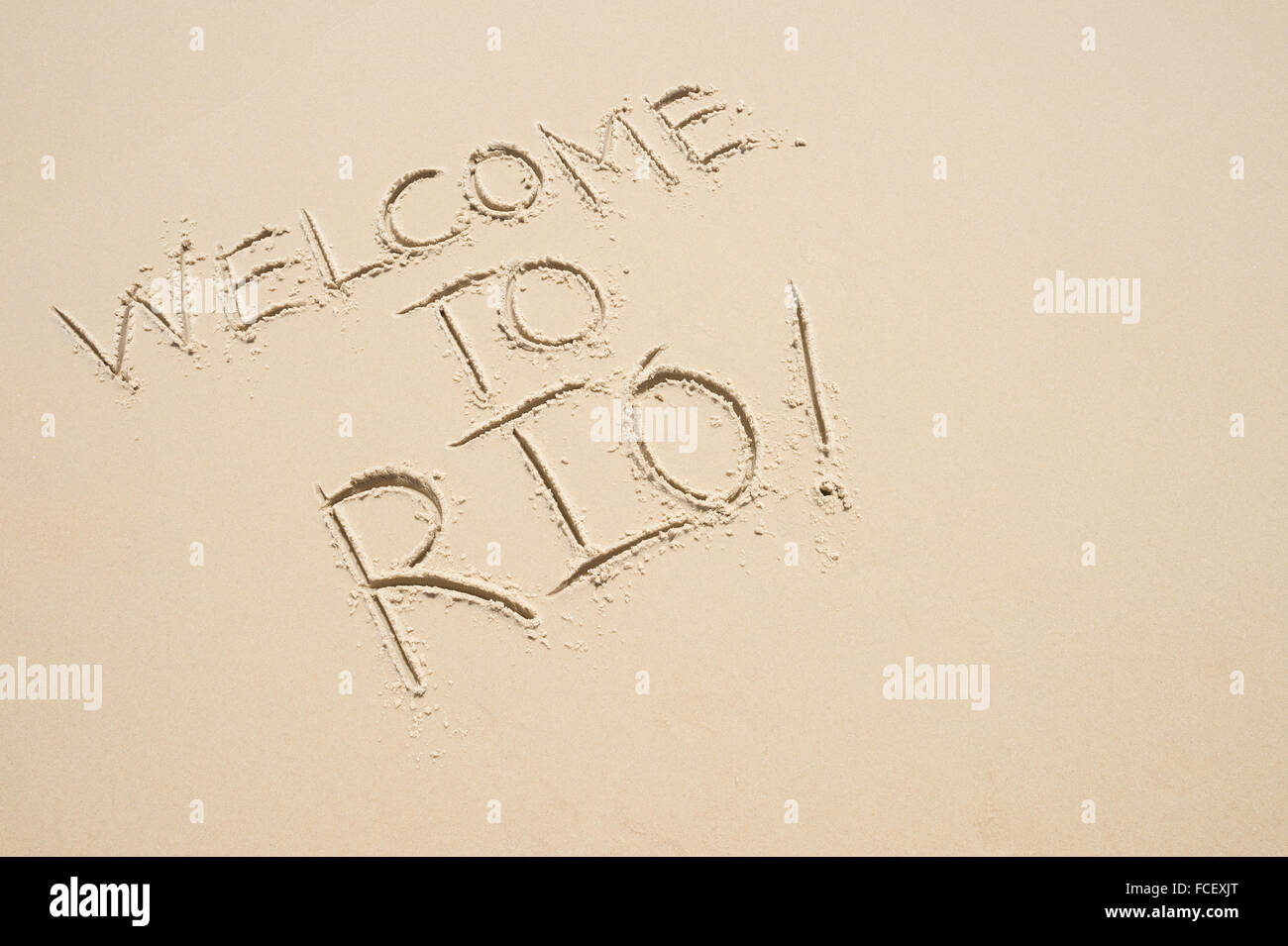 Welcome to Rio (as in, de Janeiro) message handwritten in smooth sand ...