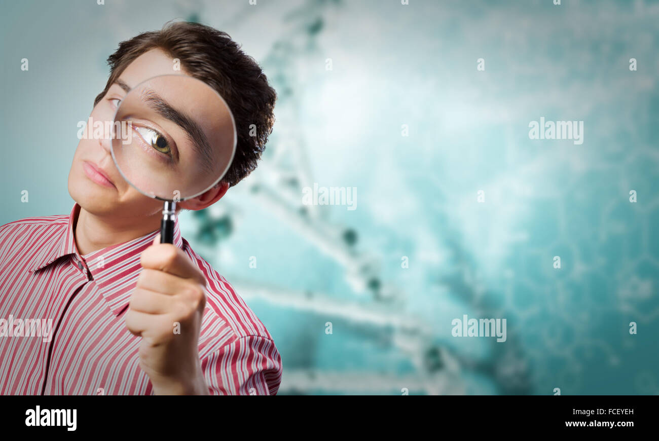 Young man in casual looking in magnifier Stock Photo - Alamy