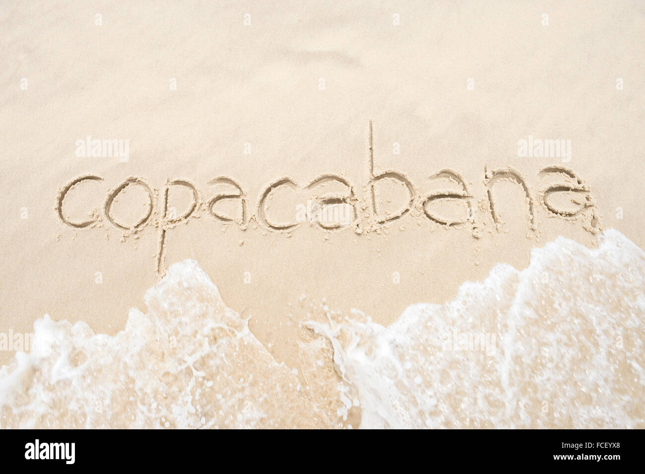 Copacabana, the famous beach, message handwritten on smooth sand in Rio ...