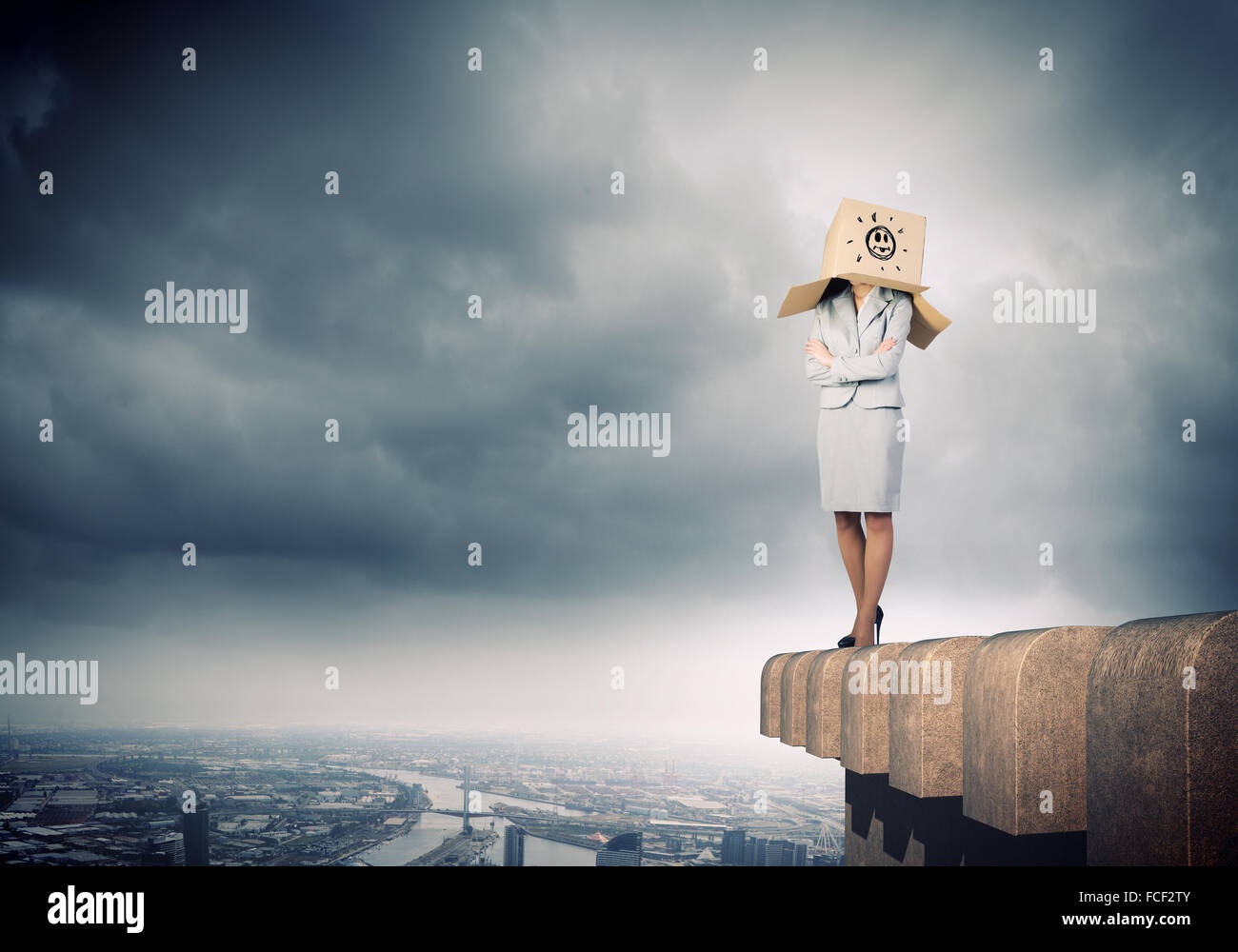 Businesswoman in suit wearing carton box on head Stock Photo - Alamy